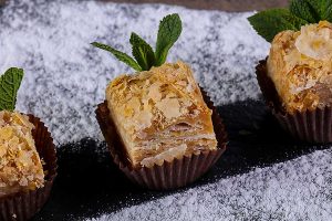 Mille-feuille is a three layers of French pastry dipped in vanilla cream.